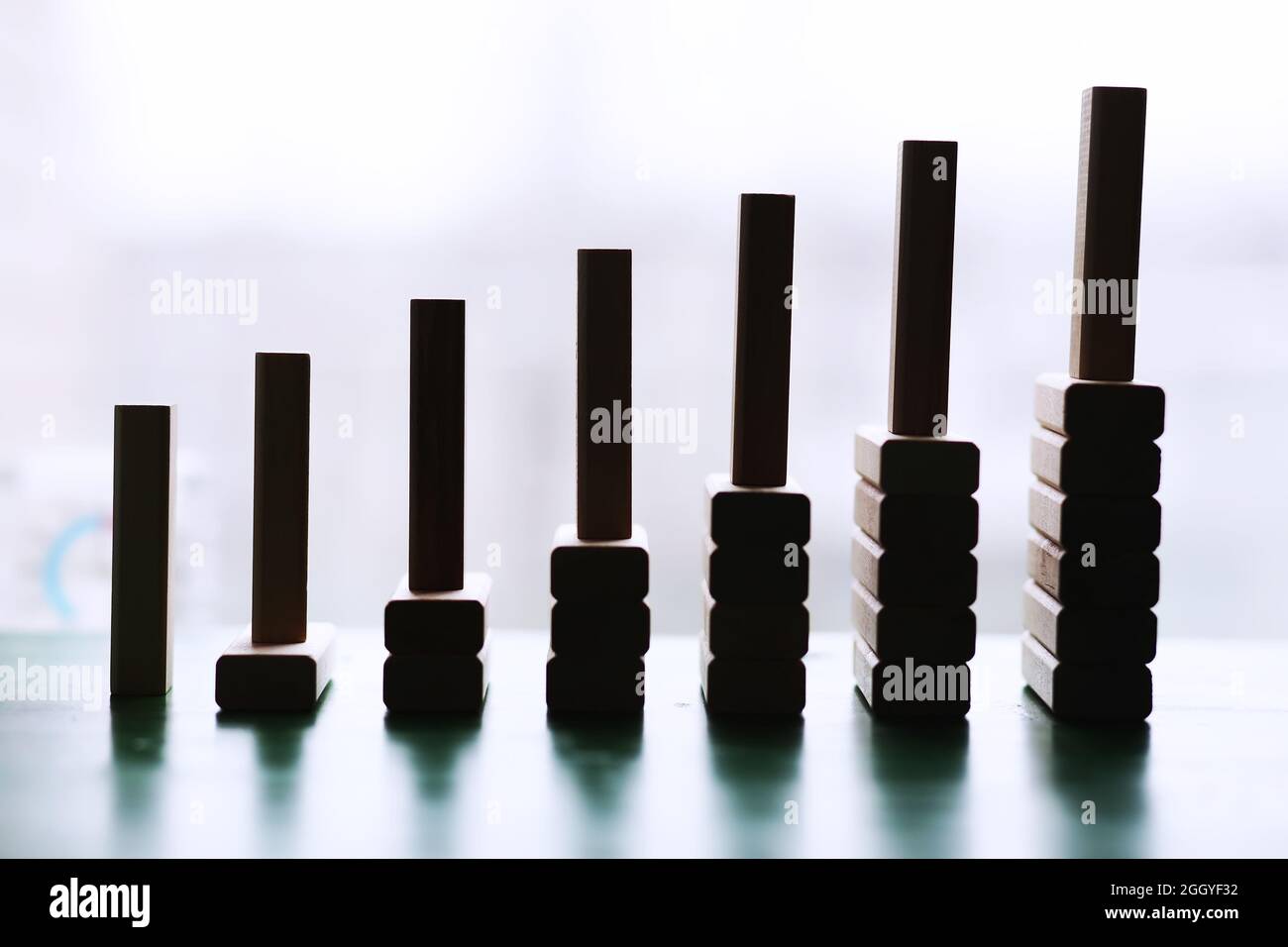 Stick wood block standing on stacked square wood blocks, abstract ...