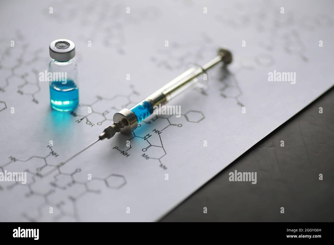 small jars with injection and syringe for injection on blue background ...