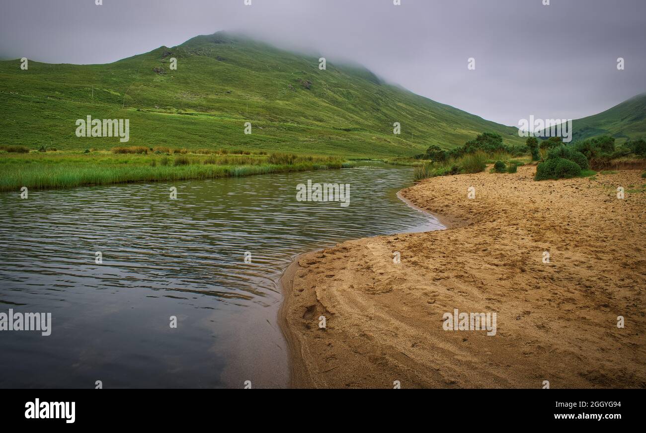 Beautiful landscape scenery of sandy beach and green hills in the ...