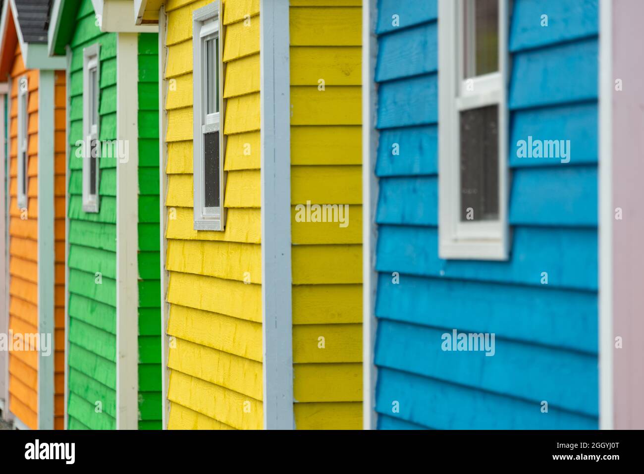 A row of small colorful painted huts or sheds made of wood. The vibrant ...
