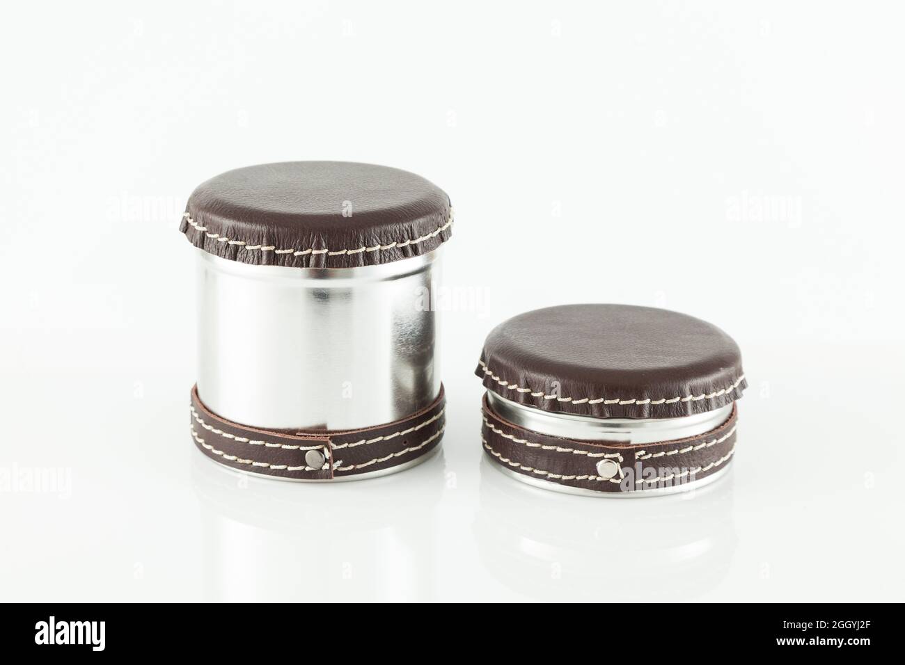 Multipurpose metal container decorated with leather; photo on white ...