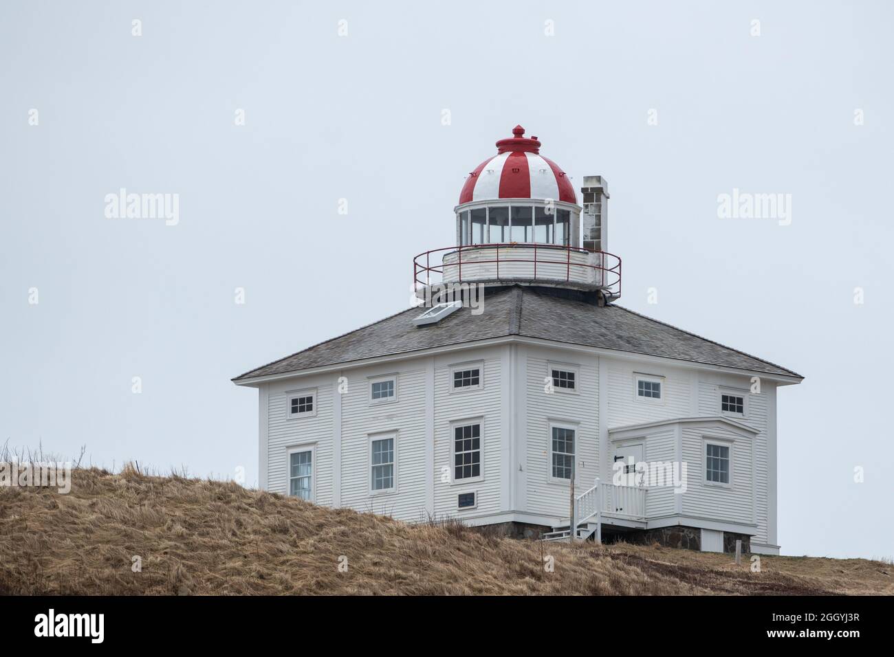 A historic square white and red wooden tower lighthouse with a round ...