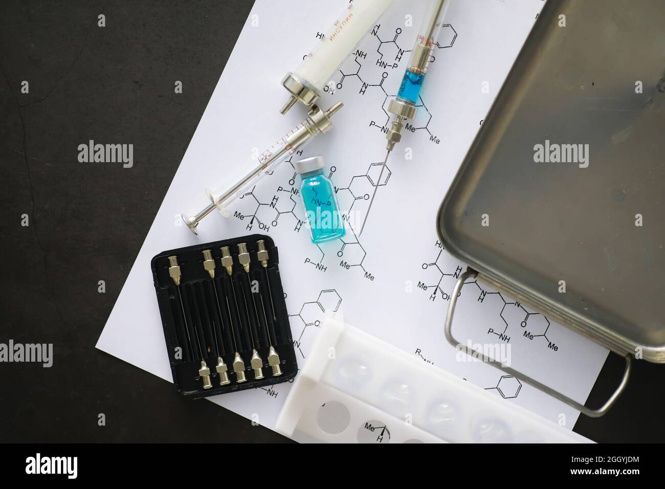 small jars with injection and syringe for injection on blue background ...