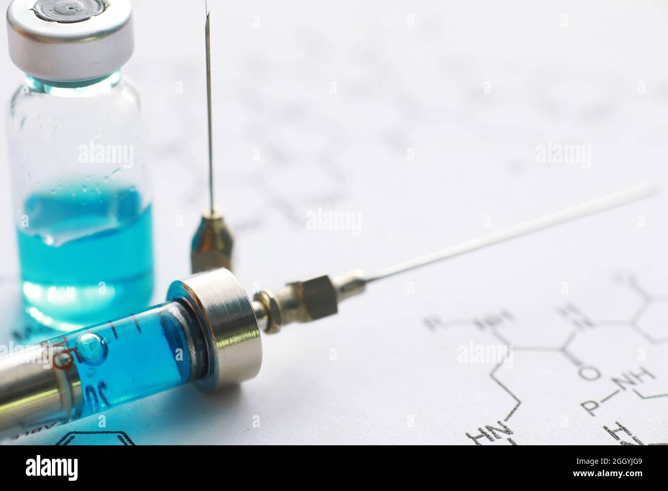 small jars with injection and syringe for injection on blue background ...