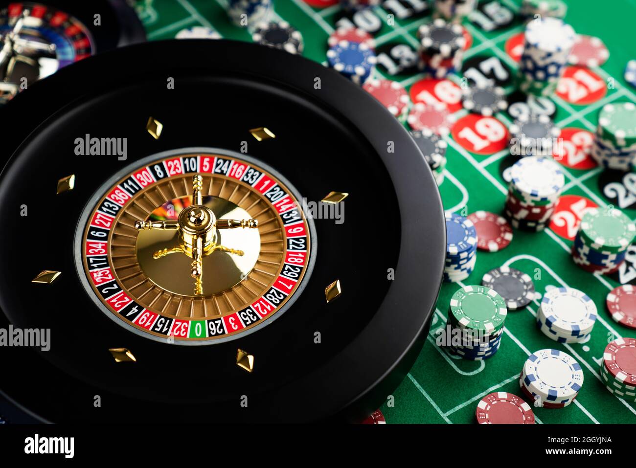 Roulette table in casino. Roulette wheel. Casino felt green table with ...