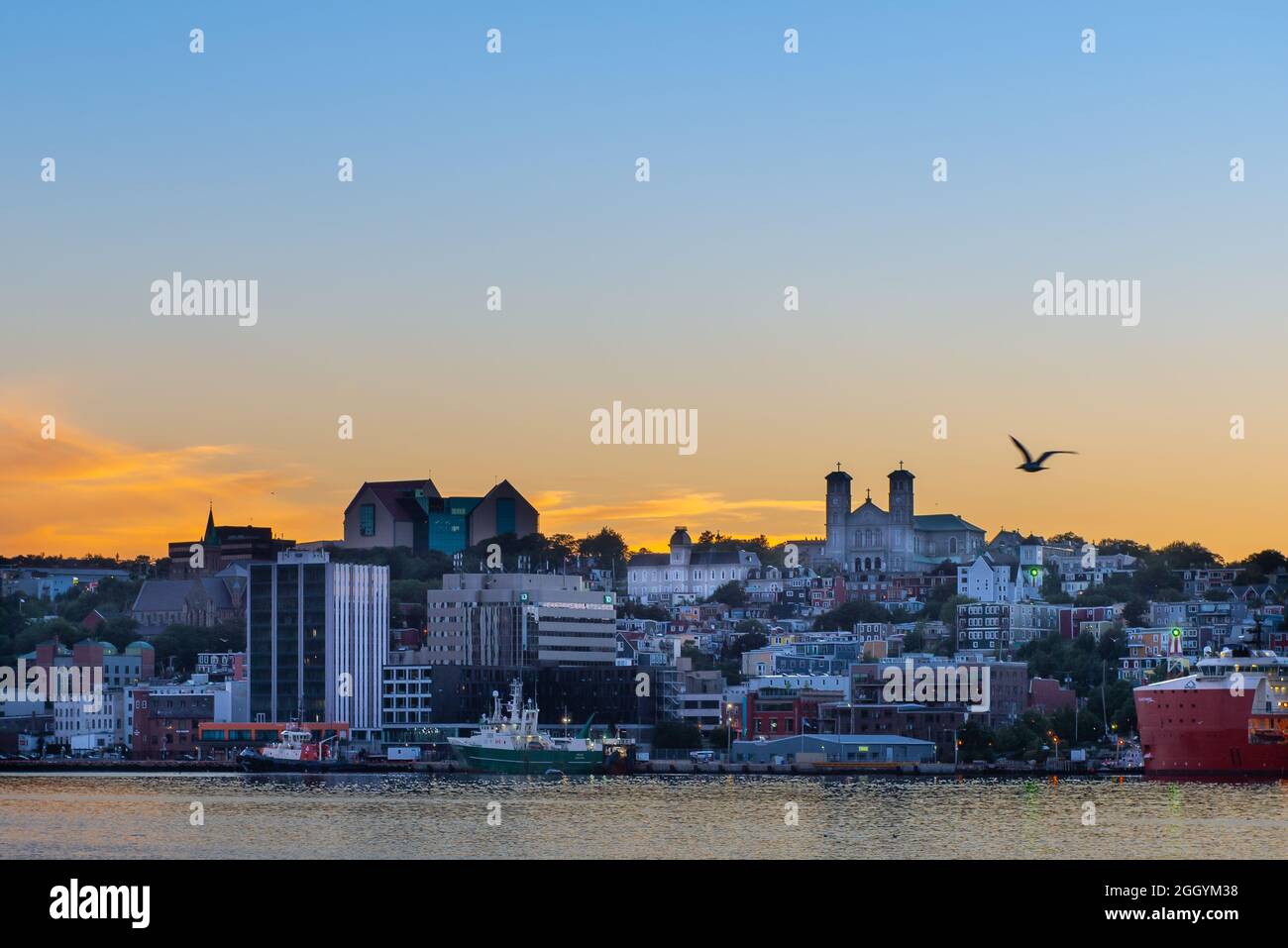St. John's, Newfoundland, waterfront harbour at sunset. The lights on ...