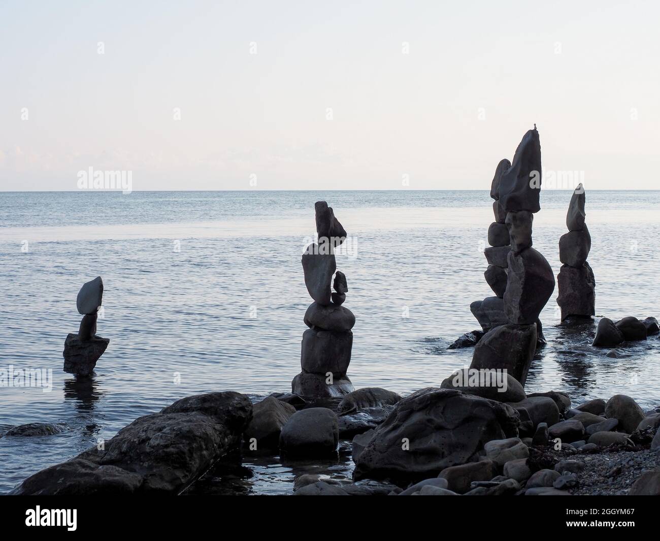 Elongated stone pyramids built on the shores of calm sea Stock Photo ...