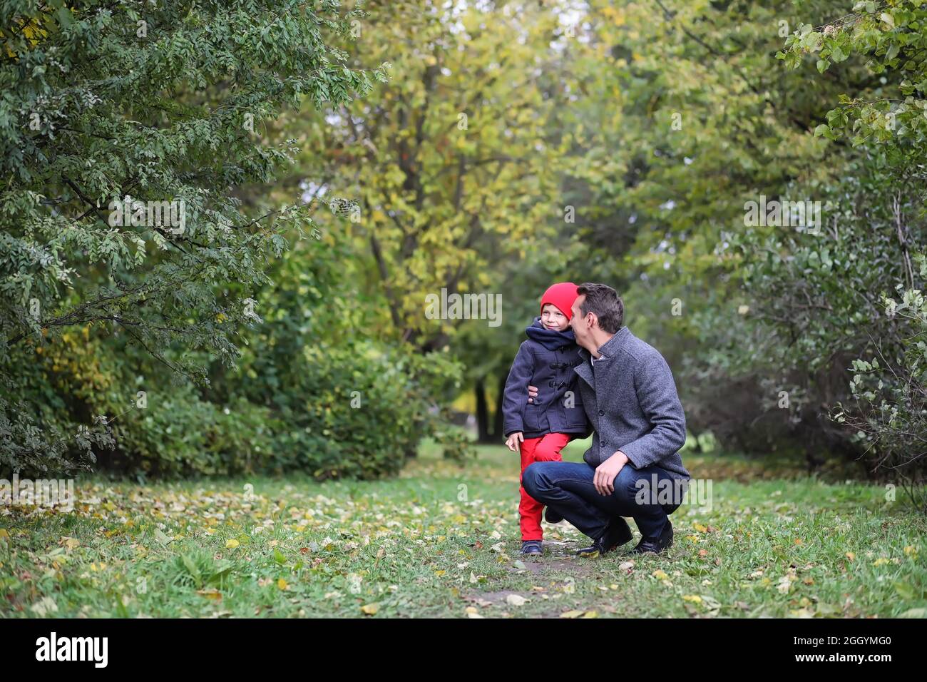 Young family with children on a walk in the park in spring Stock Photo ...
