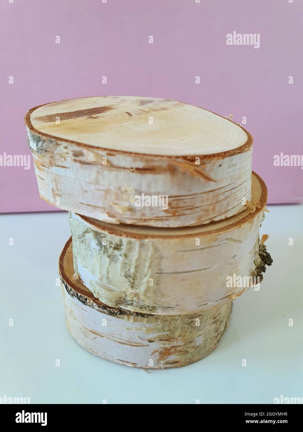 Stack of birch wood stands on white table Stock Photo - Alamy