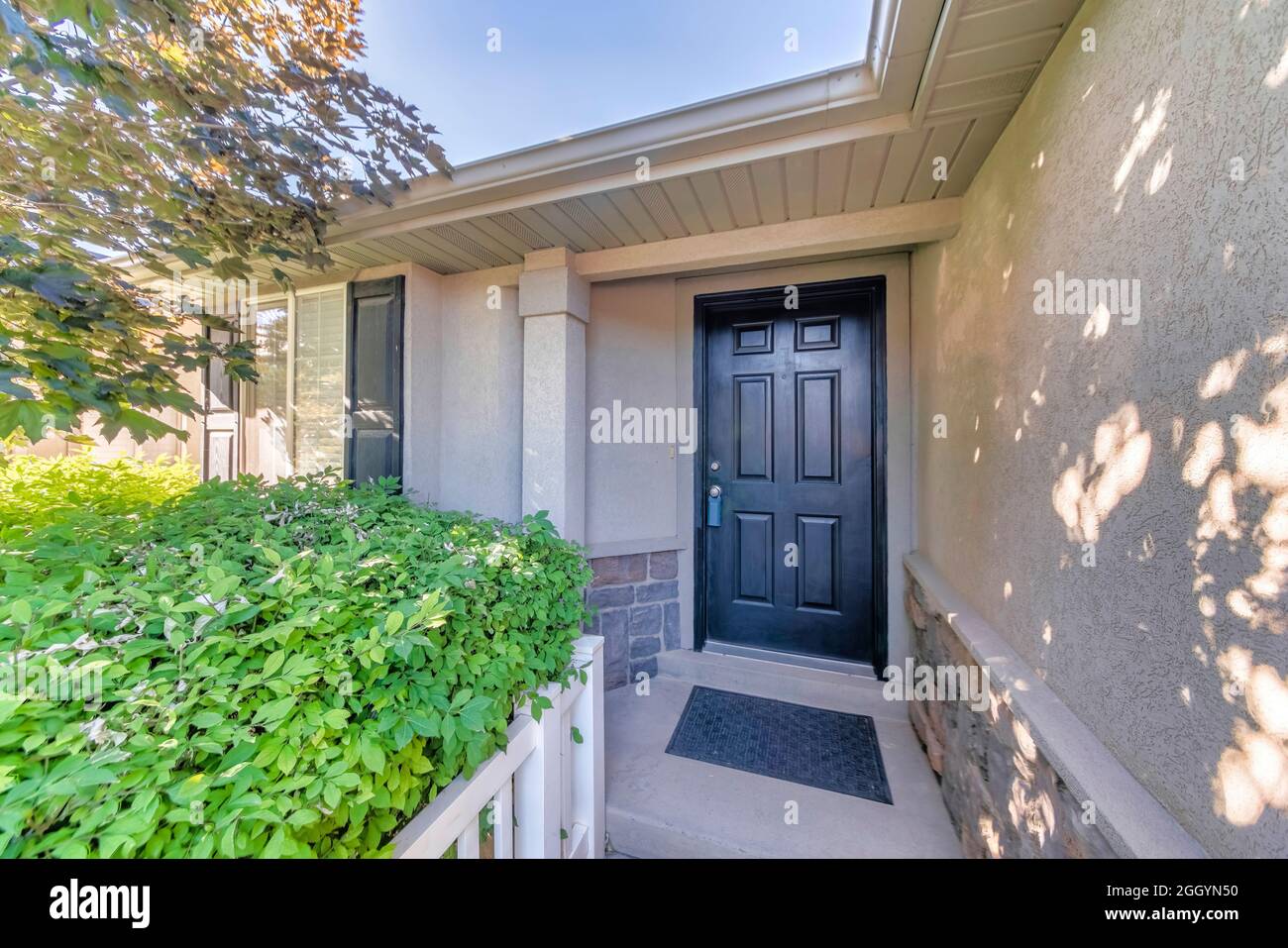 Front porch of a house with shrubs and trees at the front Stock Photo ...
