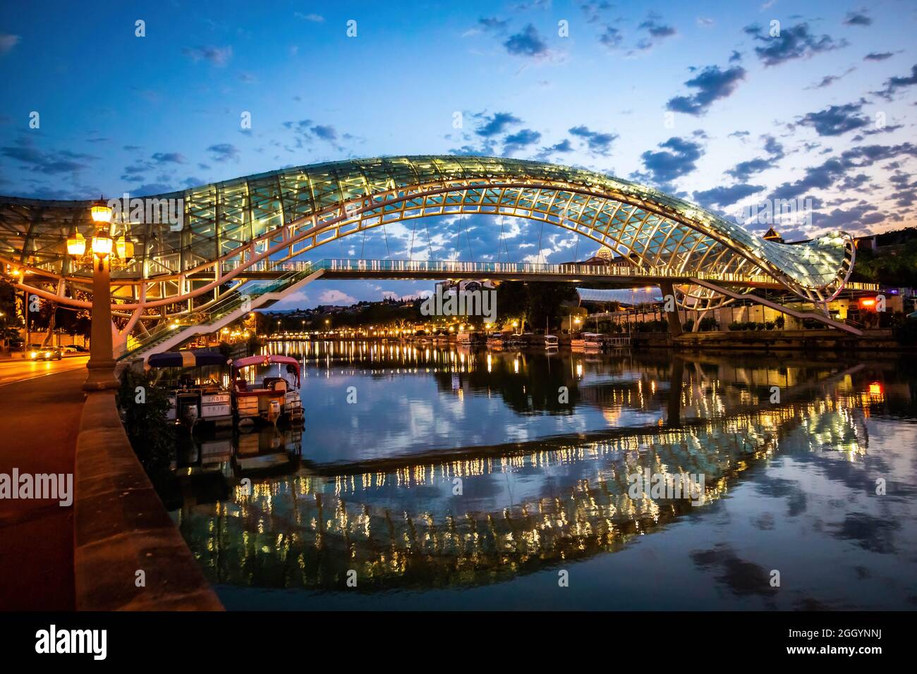 Scenic view of Bridge of Peace illuminated at night in Tbilisi town ...