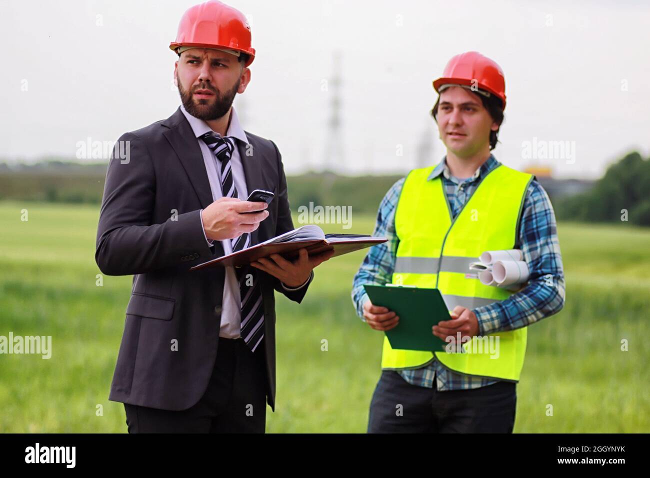 construction two man in the field Stock Photo - Alamy
