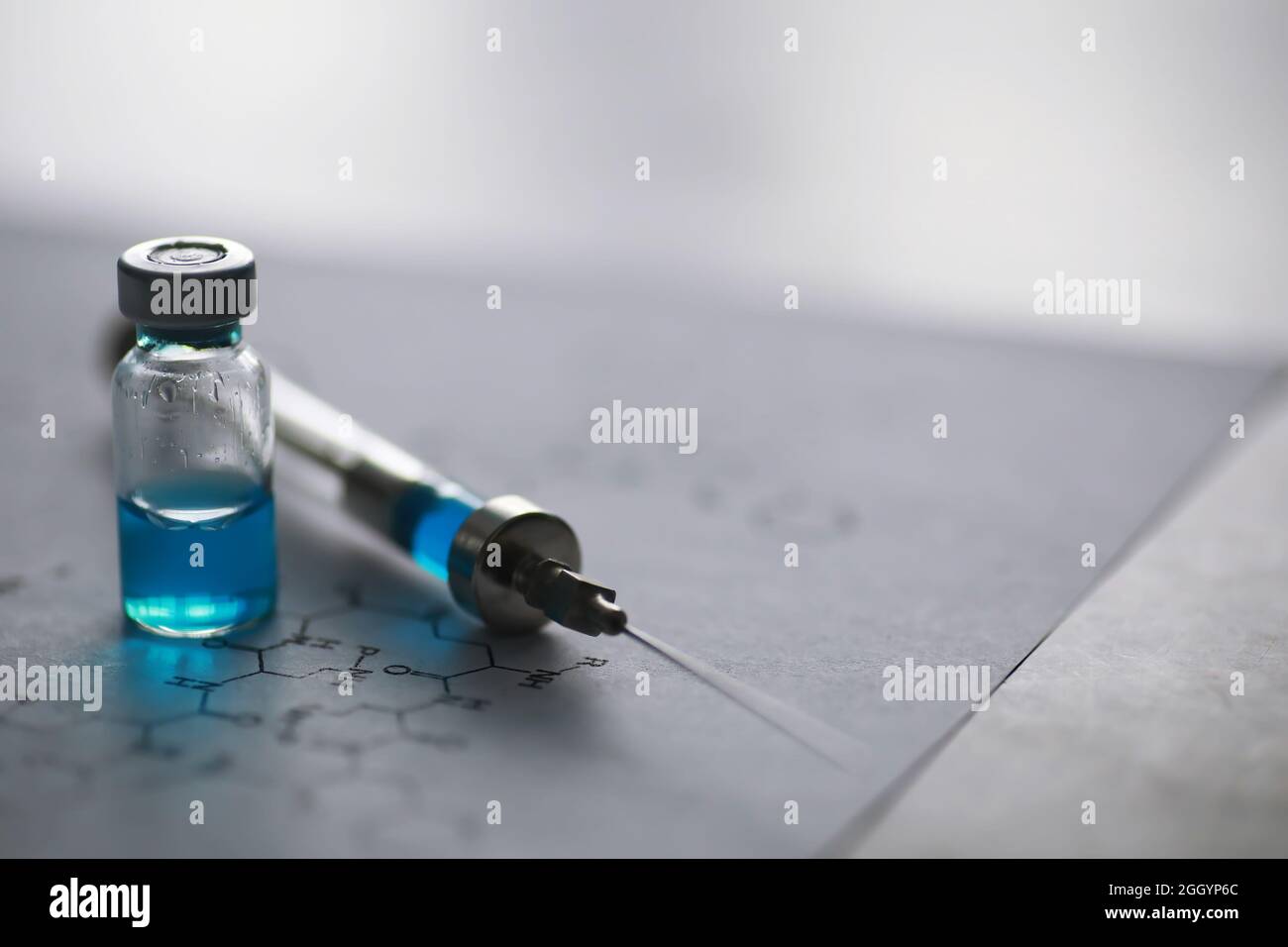 small jars with injection and syringe for injection on blue background ...