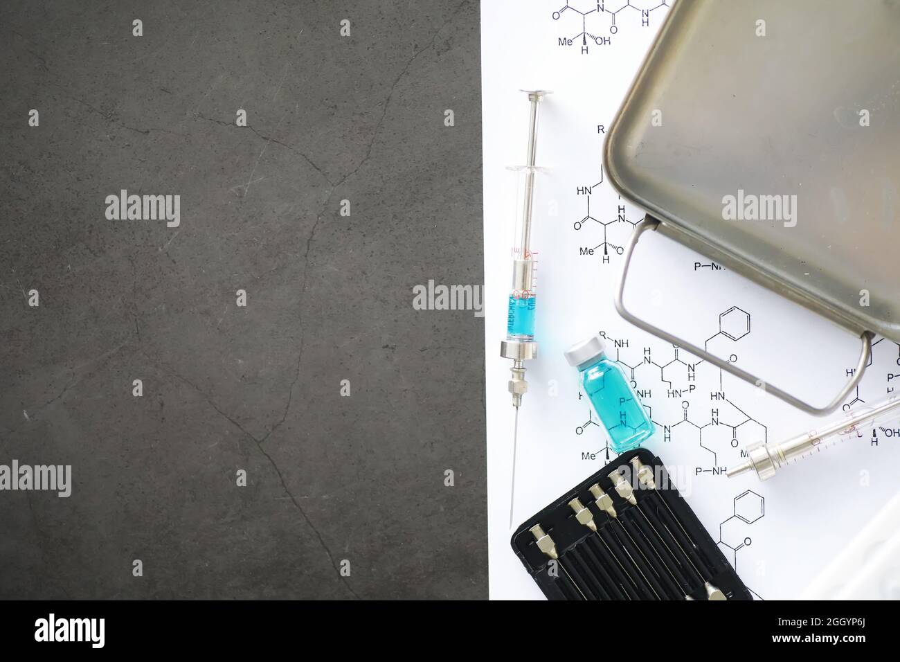 small jars with injection and syringe for injection on blue background ...