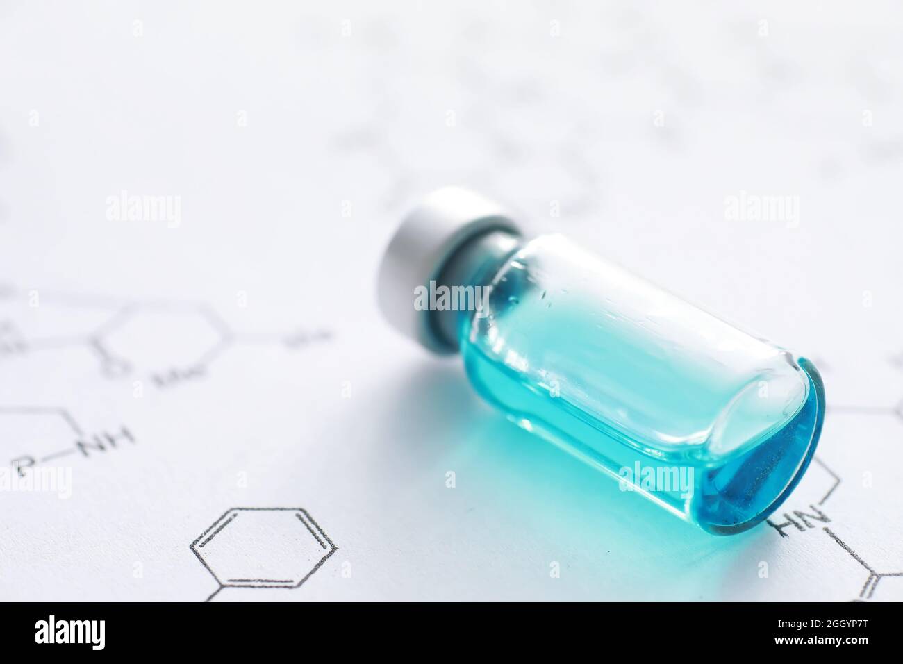 small jars with injection and syringe for injection on blue background ...