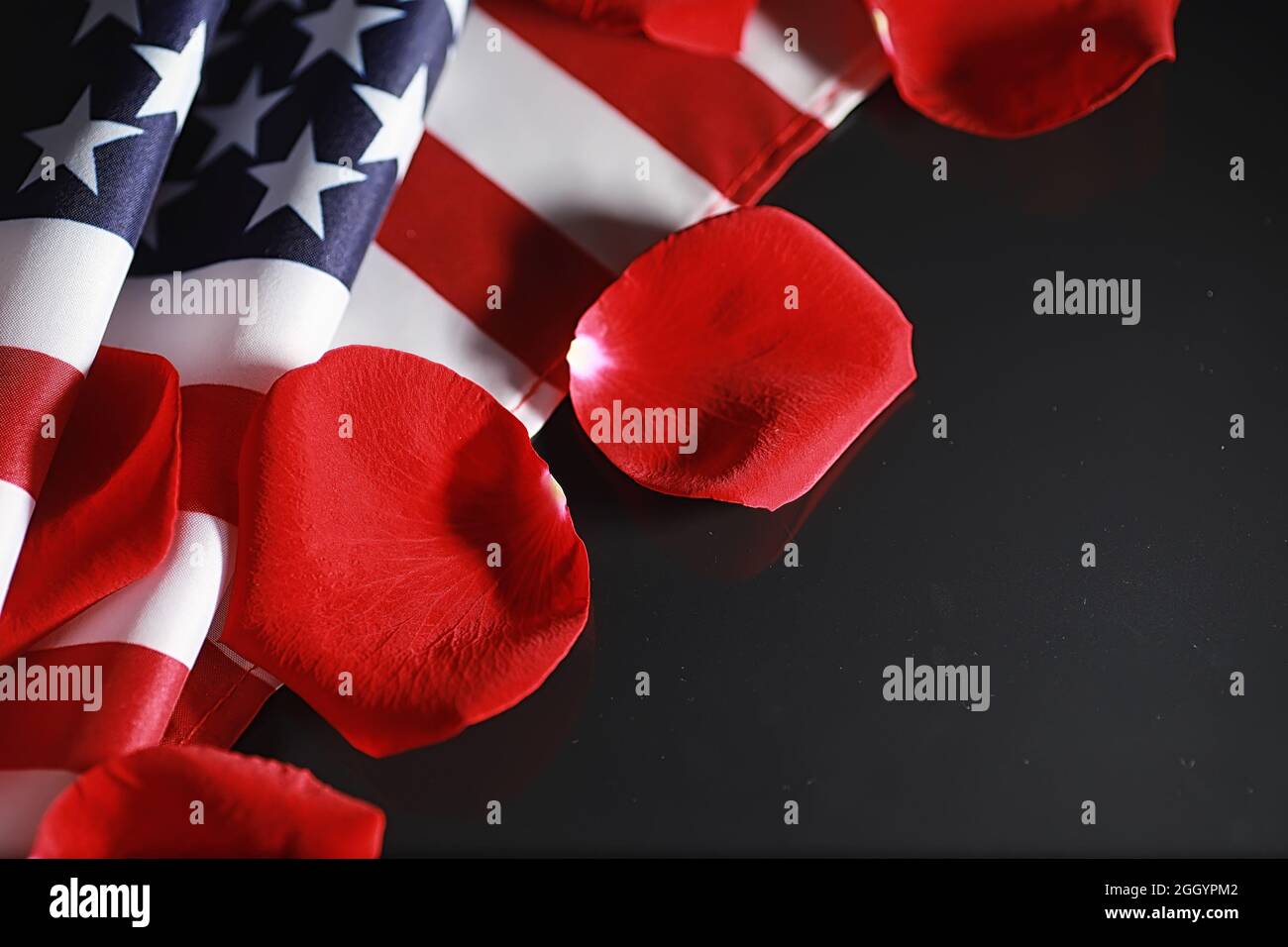 American flag and rose flower on table. Symbol of the United States of ...