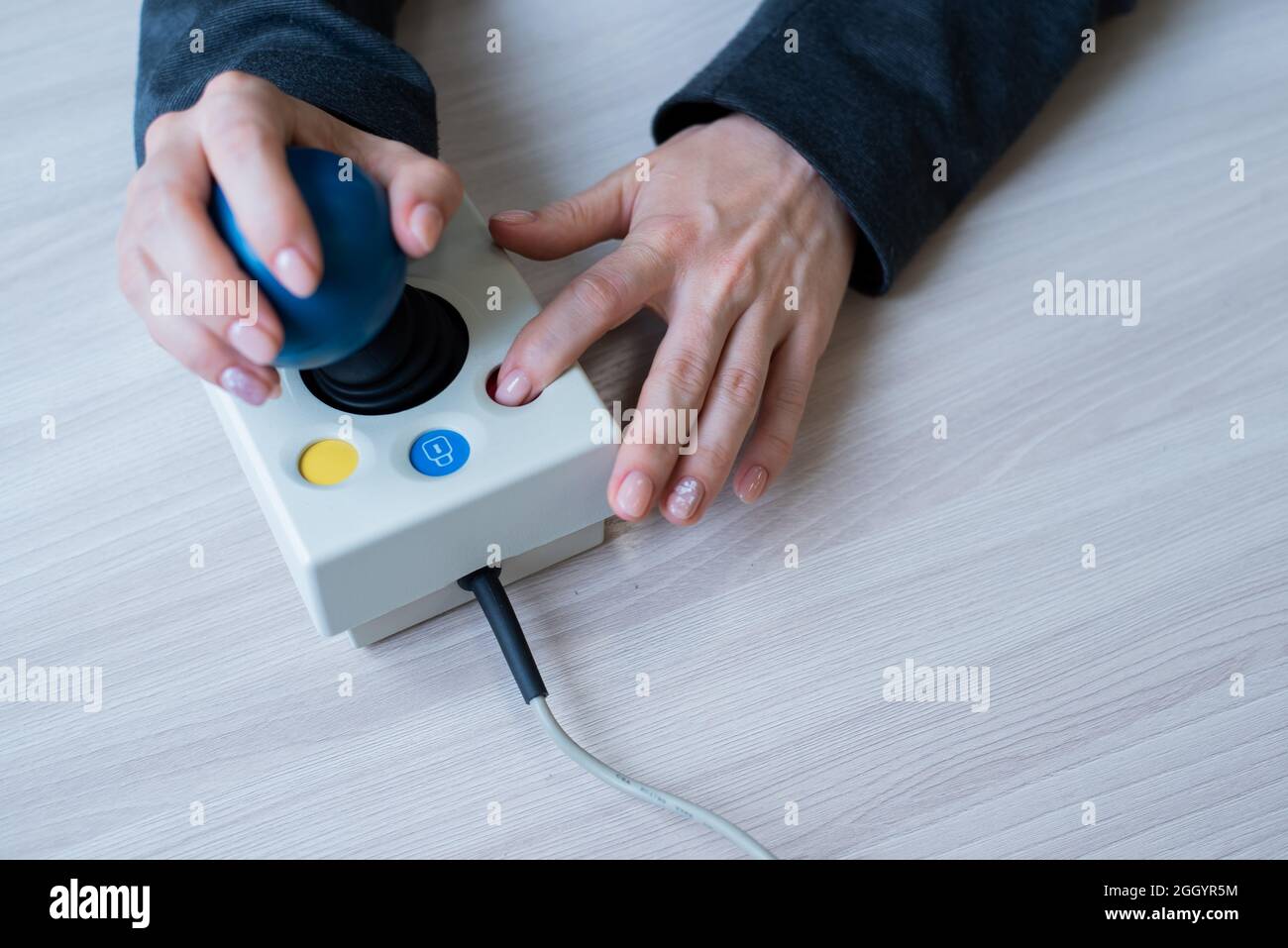 Woman with cerebral palsy works on a specialized computer mouse Stock ...