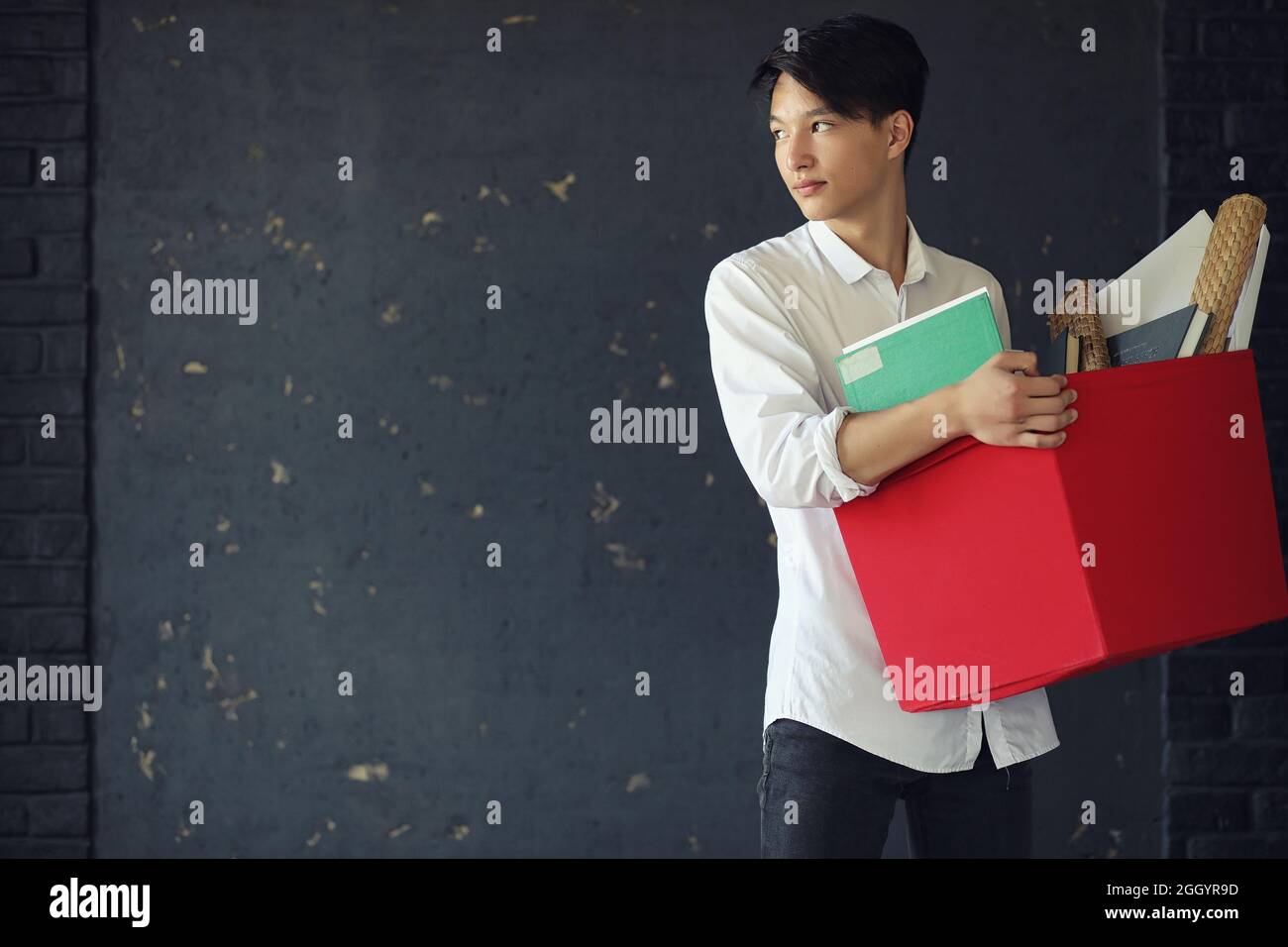 Asian young man student with books in hands Stock Photo - Alamy