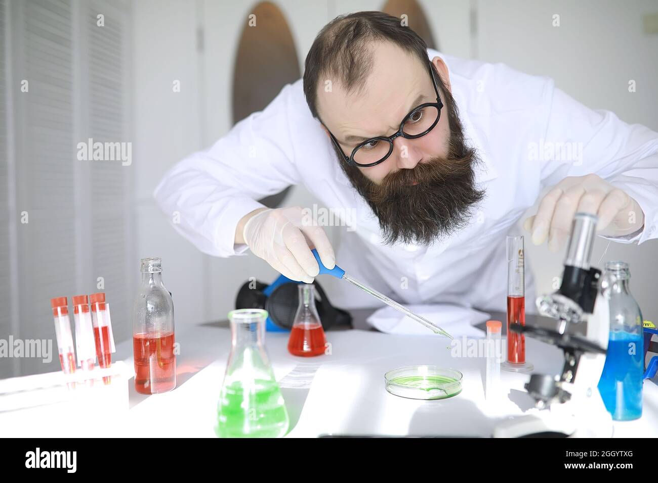 Chemist crazy. A mad scientist conducts experiments in scientific ...