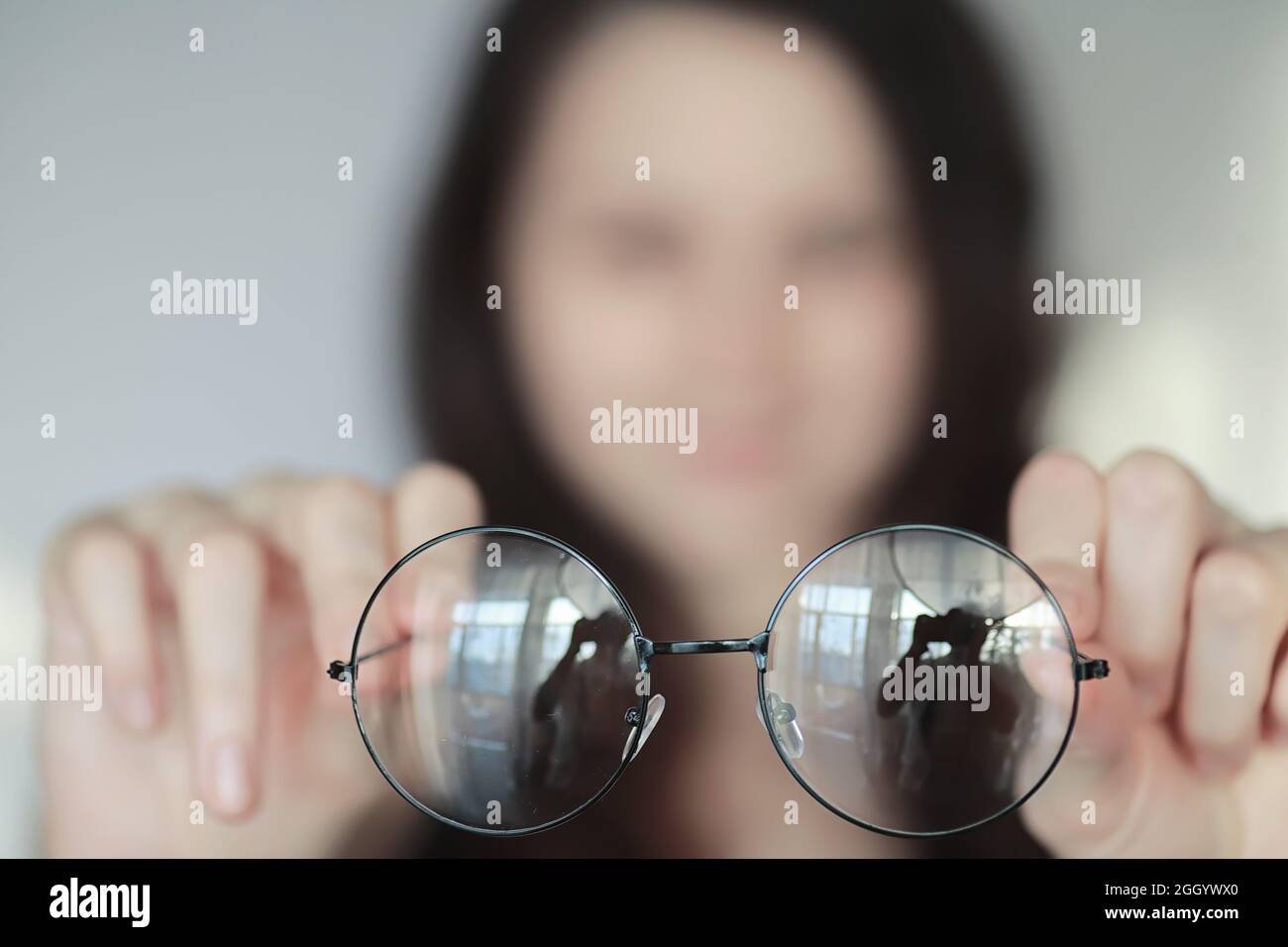 The concept of poor vision. Hold a contact lens and glasses in hand ...