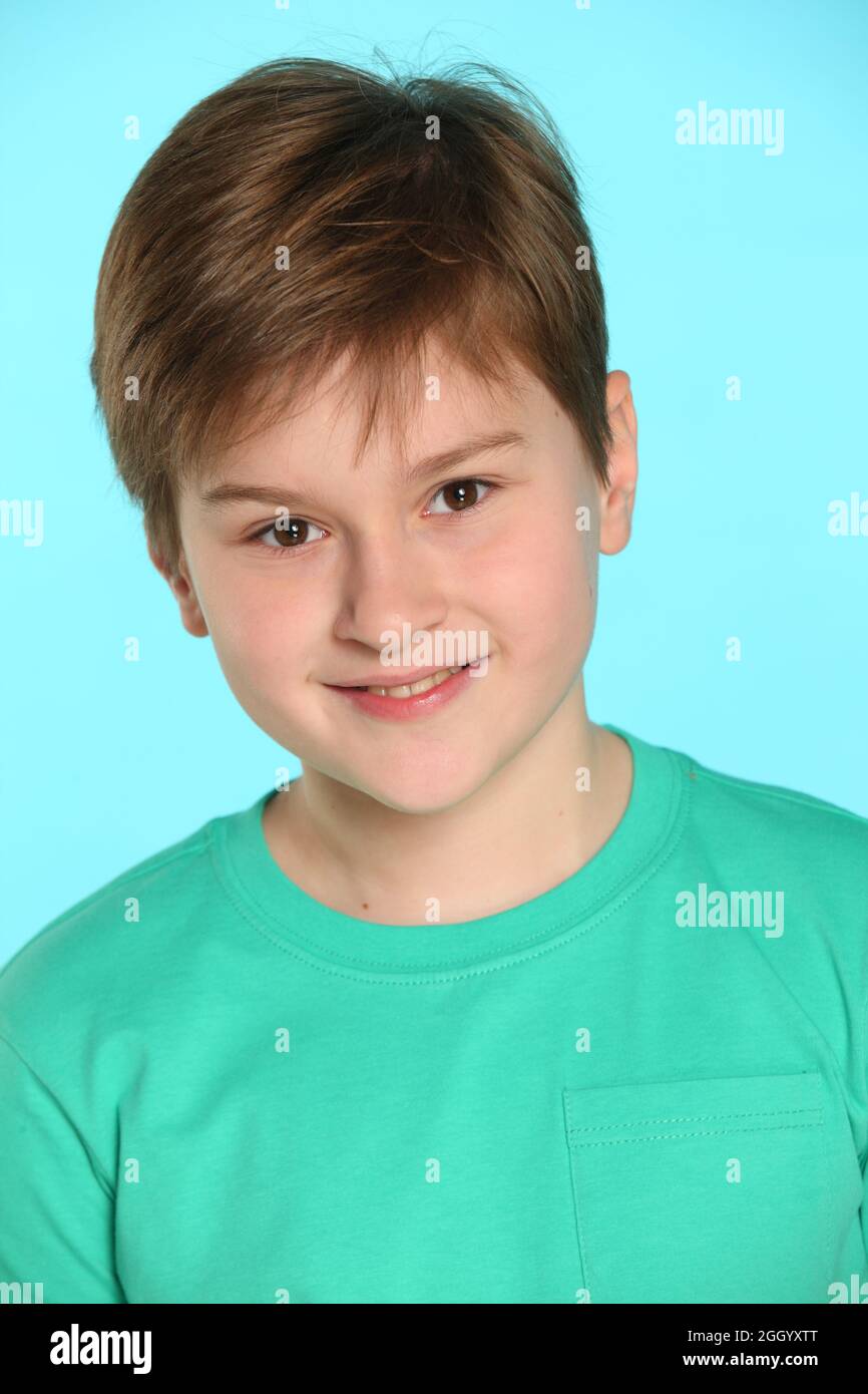 Close-up face portrait. Handsome cheerful young teen boy looks eye to ...