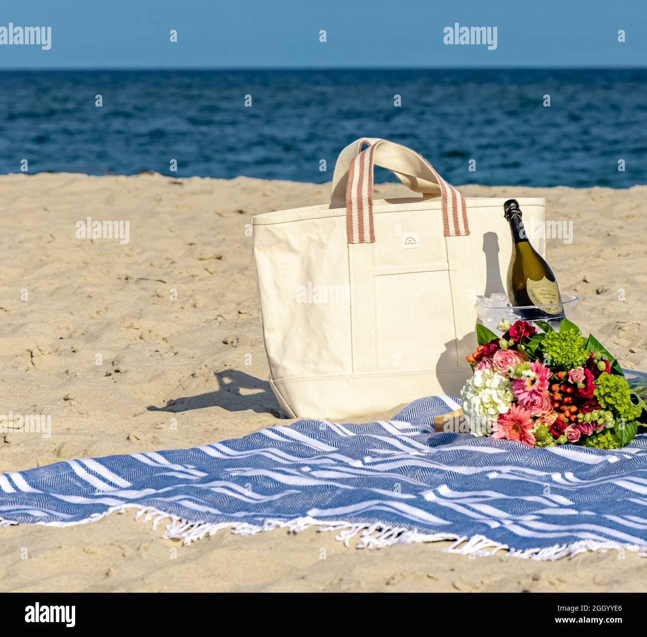 Still life on a Hampton's beach consisting of a beach blanket ...