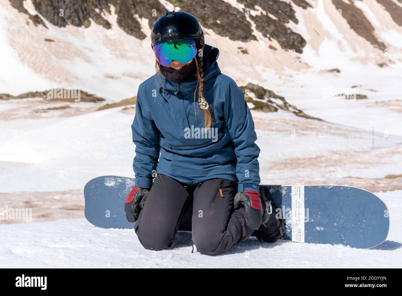Young woman snowboarder in motion on snowboard in mountains Stock Photo ...