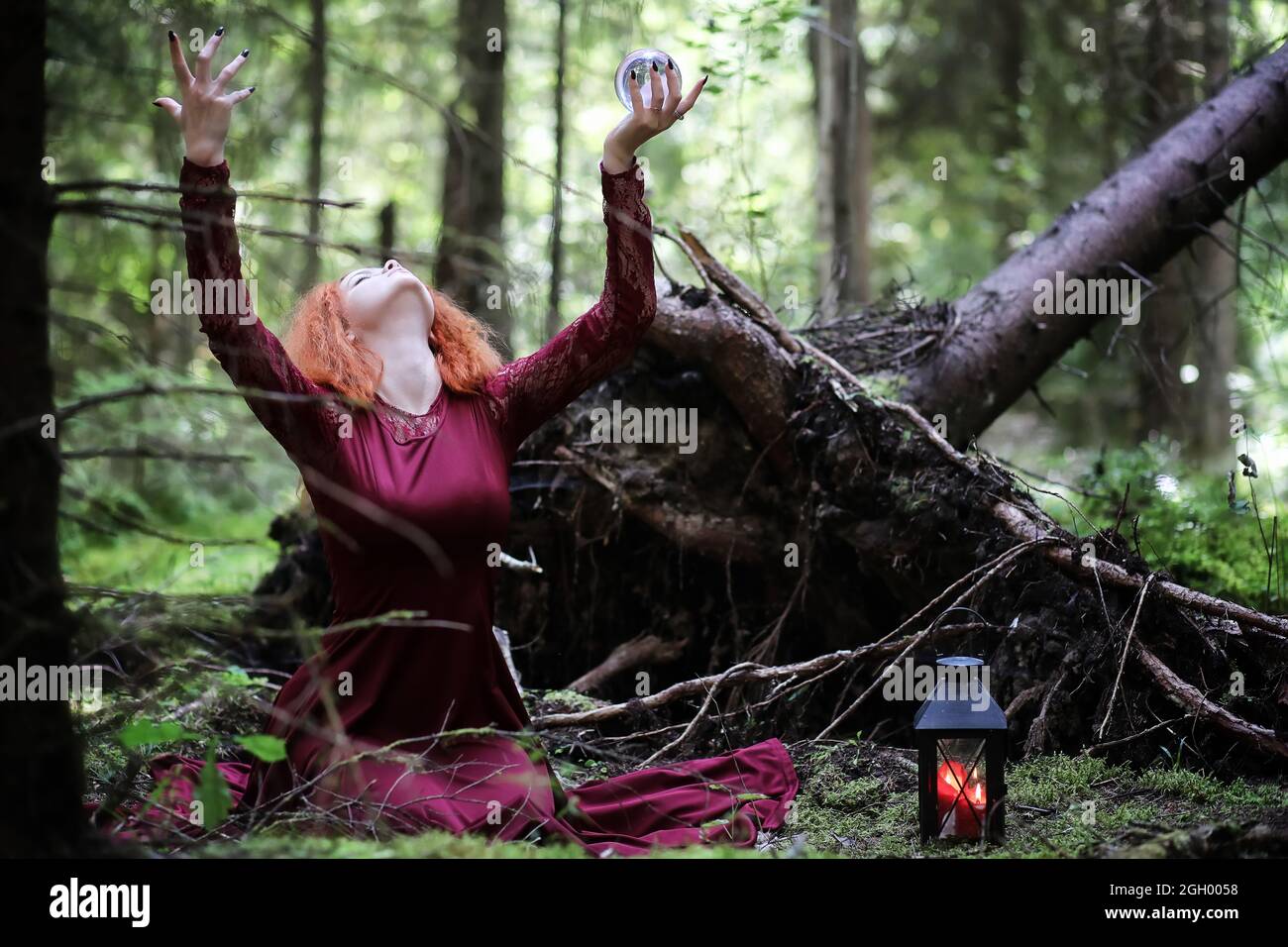 Witch holds a ritual in the depths of the forest Stock Photo - Alamy