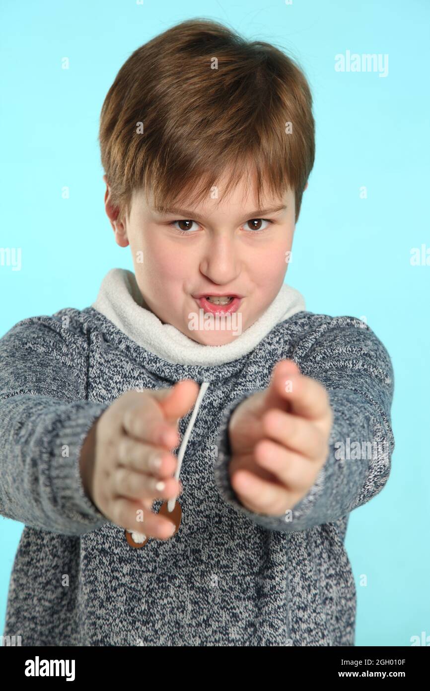 Handsome fashionable cheerful teenage boy energetically asserts ...