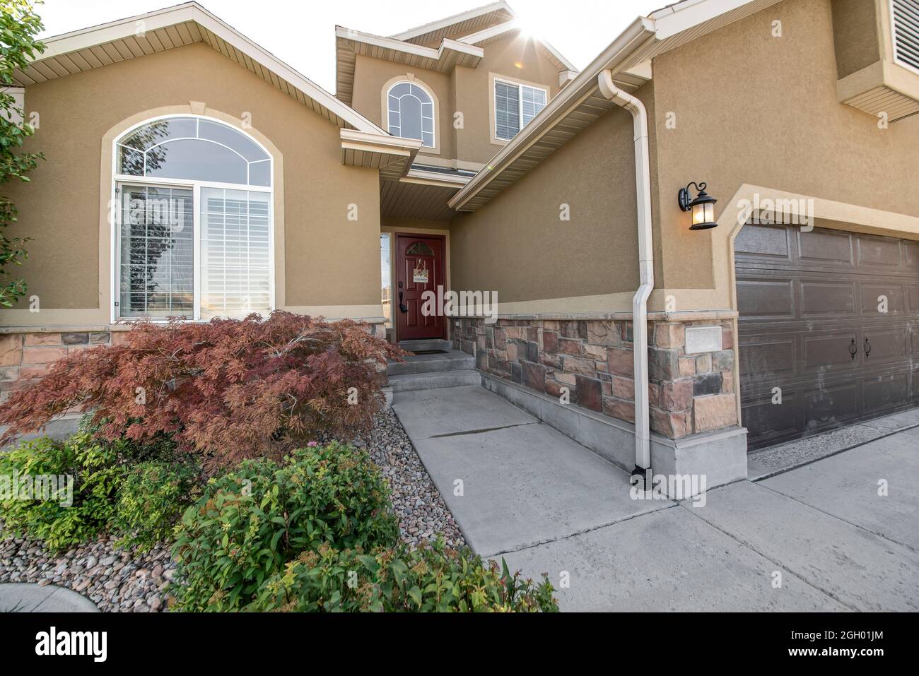 Exterior of a large two-storey house with arched windows and stone ...