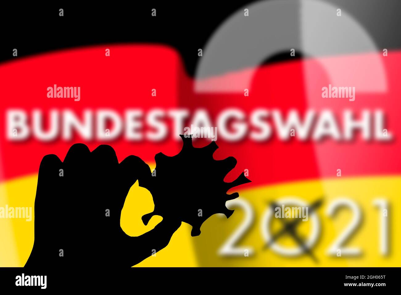 A person hand hold coronavirus over German flag and election symbol ...
