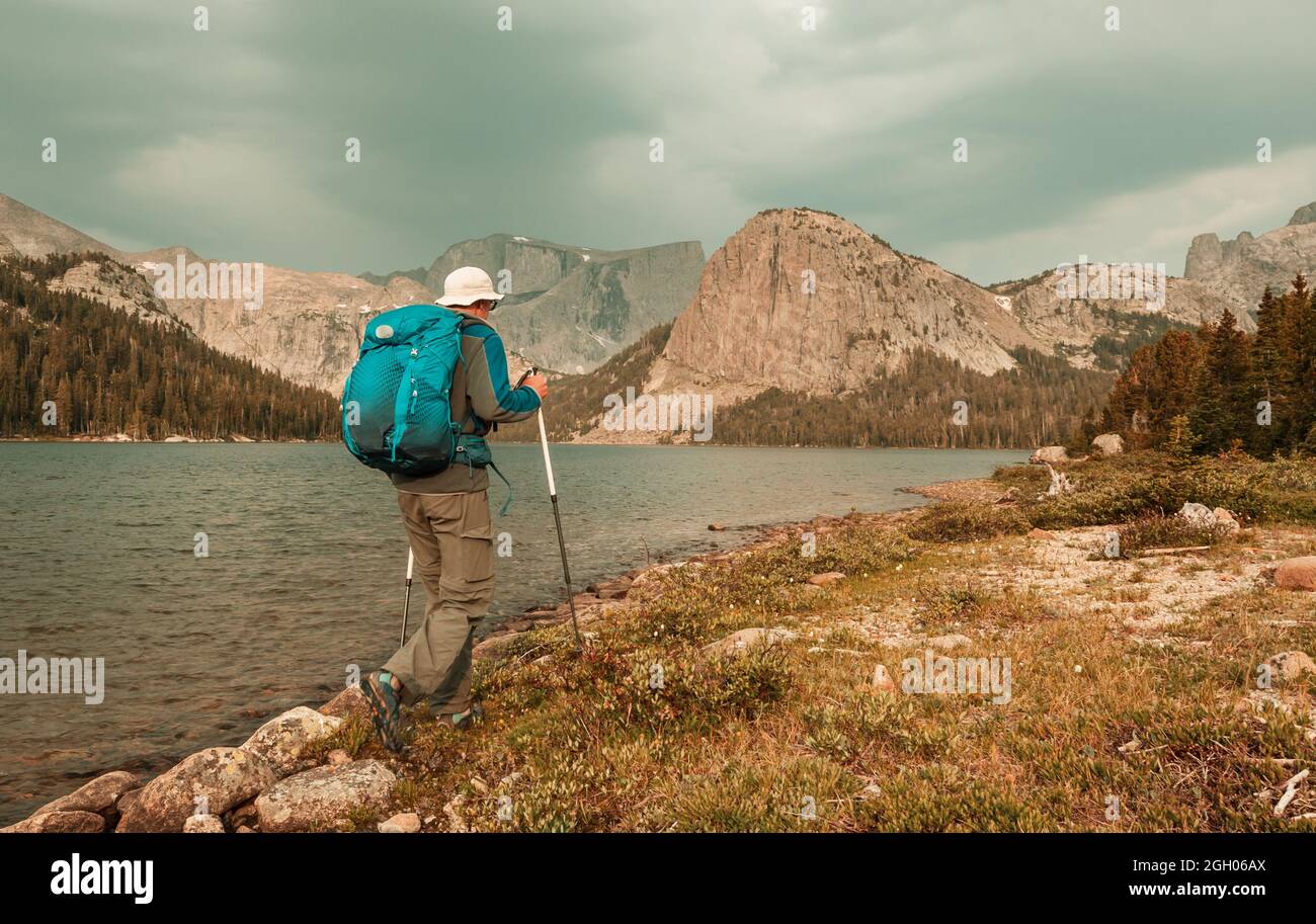 Backpacker in hike in the high mountains Stock Photo - Alamy