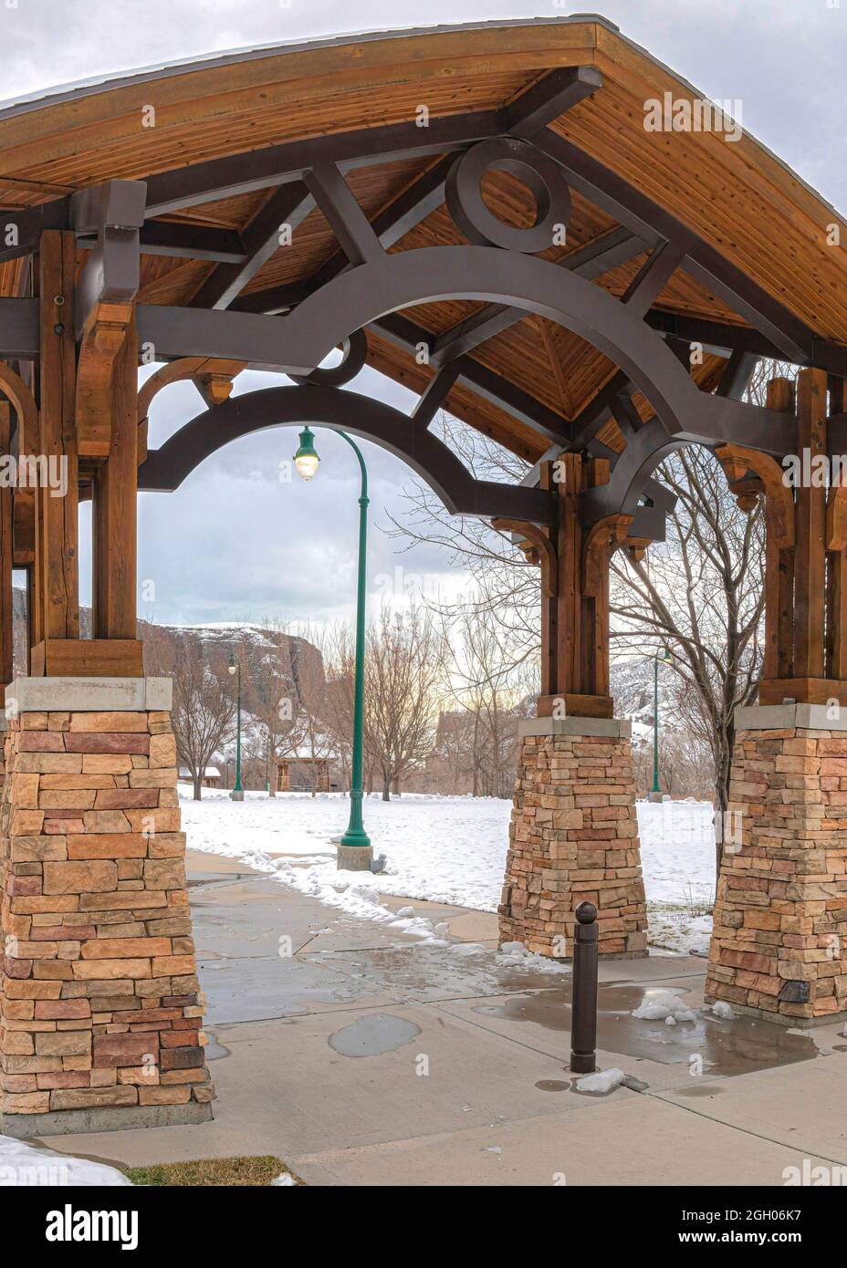 Vertical A beautiful architecture of an open waiting shed with a green ...