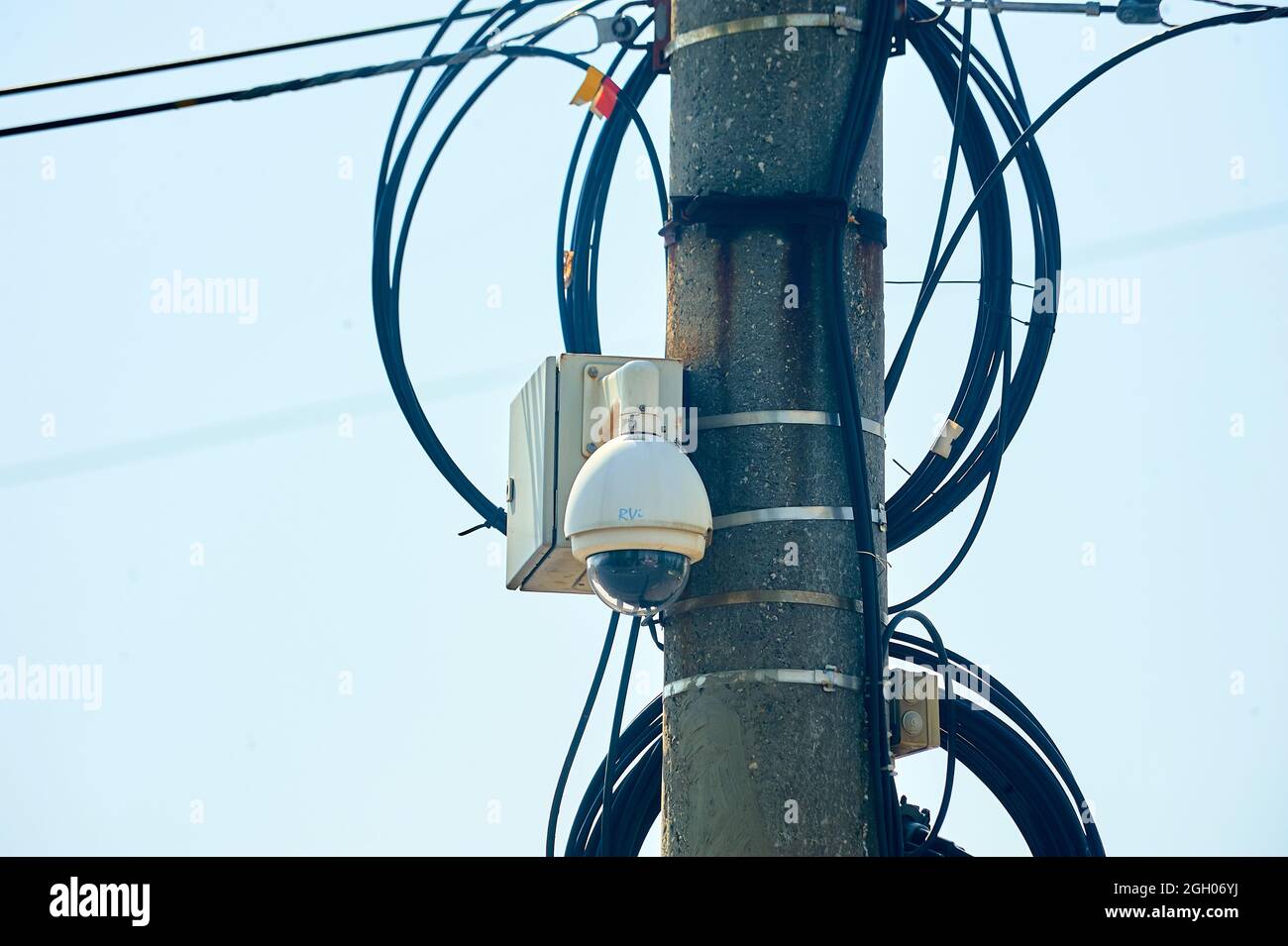 A surveillance surveillance camera is hanging on a pole Stock Photo - Alamy