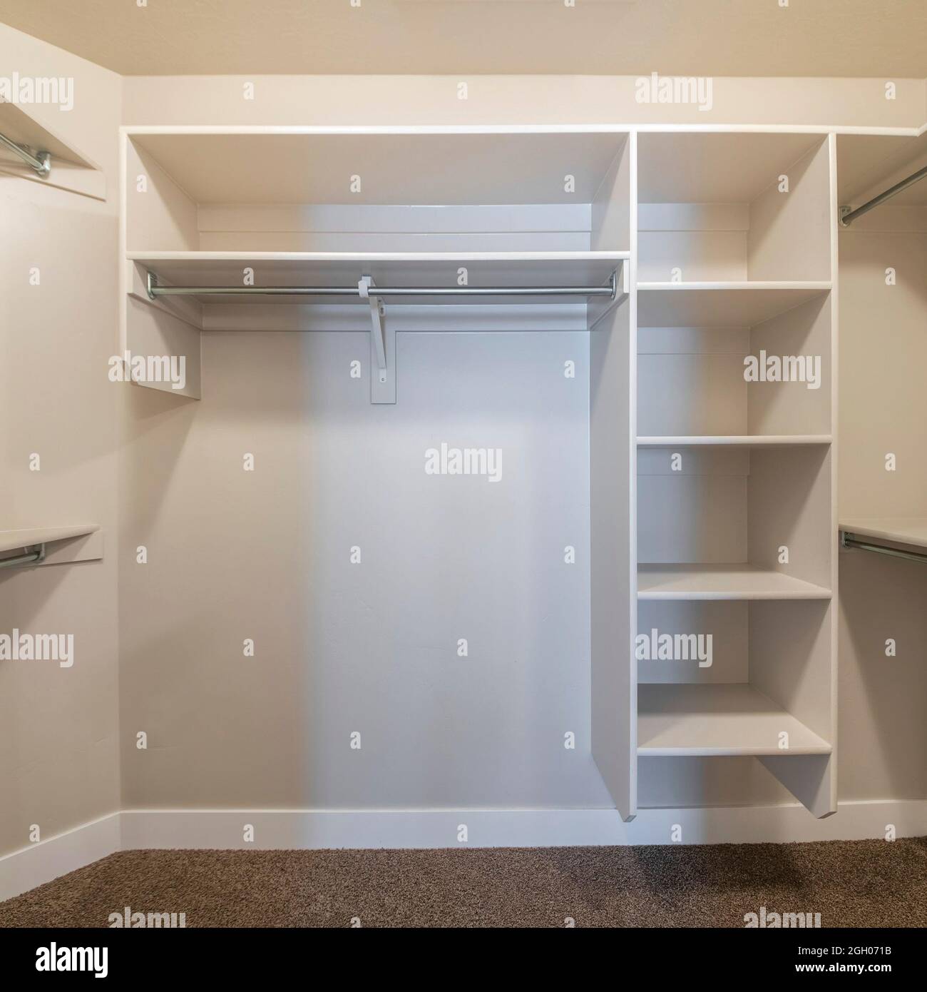 Square frame Interior of a small walk-in closet with carpeted floor ...