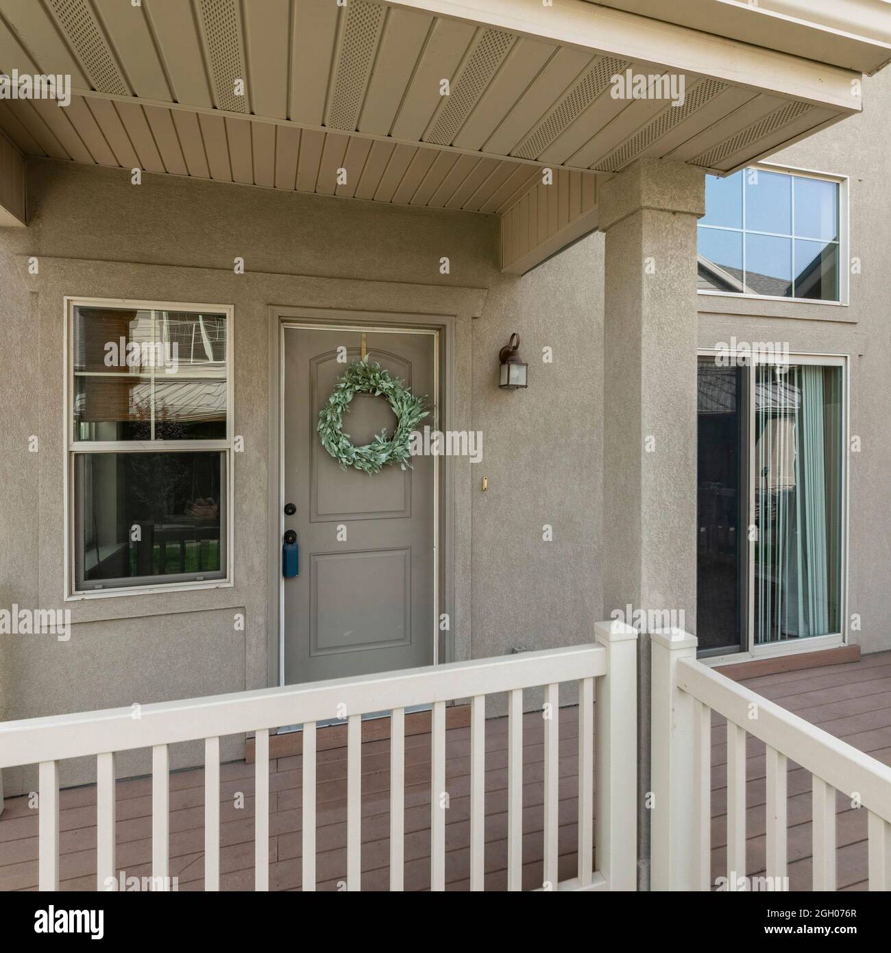 Square frame Front porch exterior of a house with wooden fence and door ...