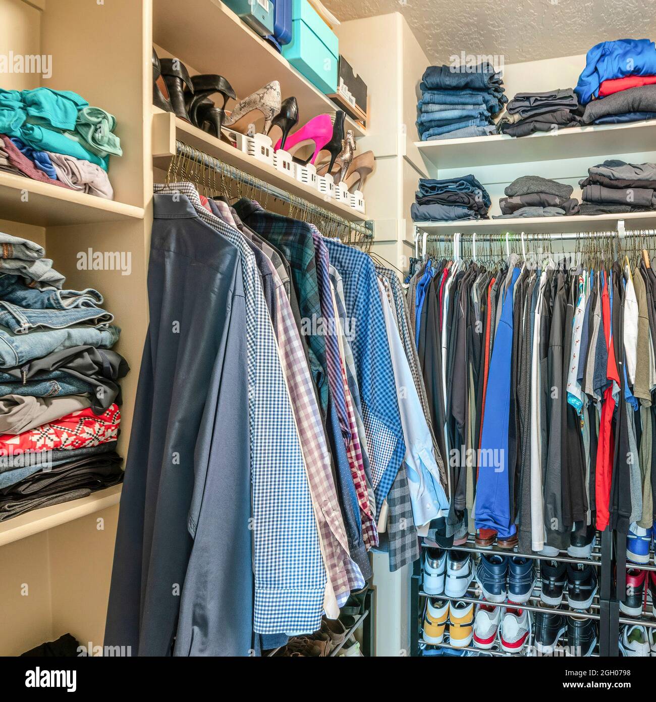 Square frame Small walk in closet with hanging rods and shelves Stock ...