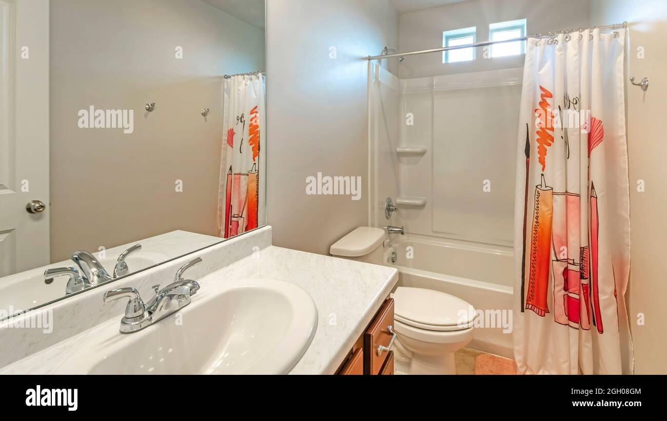 Pano Interior of a white bathroom with shower tub combo and single ...