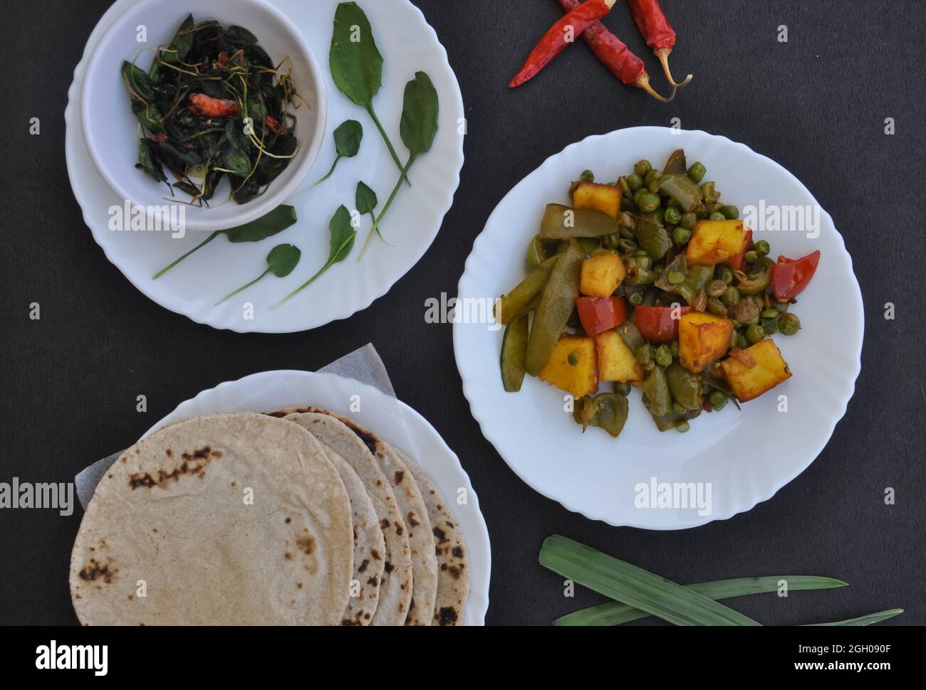 Photo of matar paneer mix veg, saag (greens) and roti (Indian bread) on ...