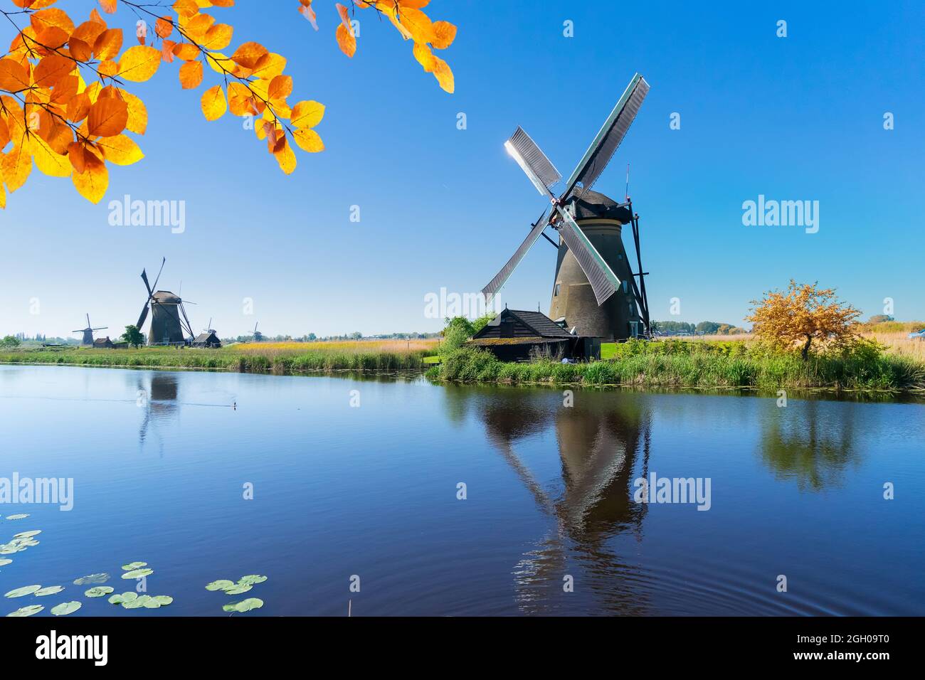 dutch windmill over river waters Stock Photo - Alamy