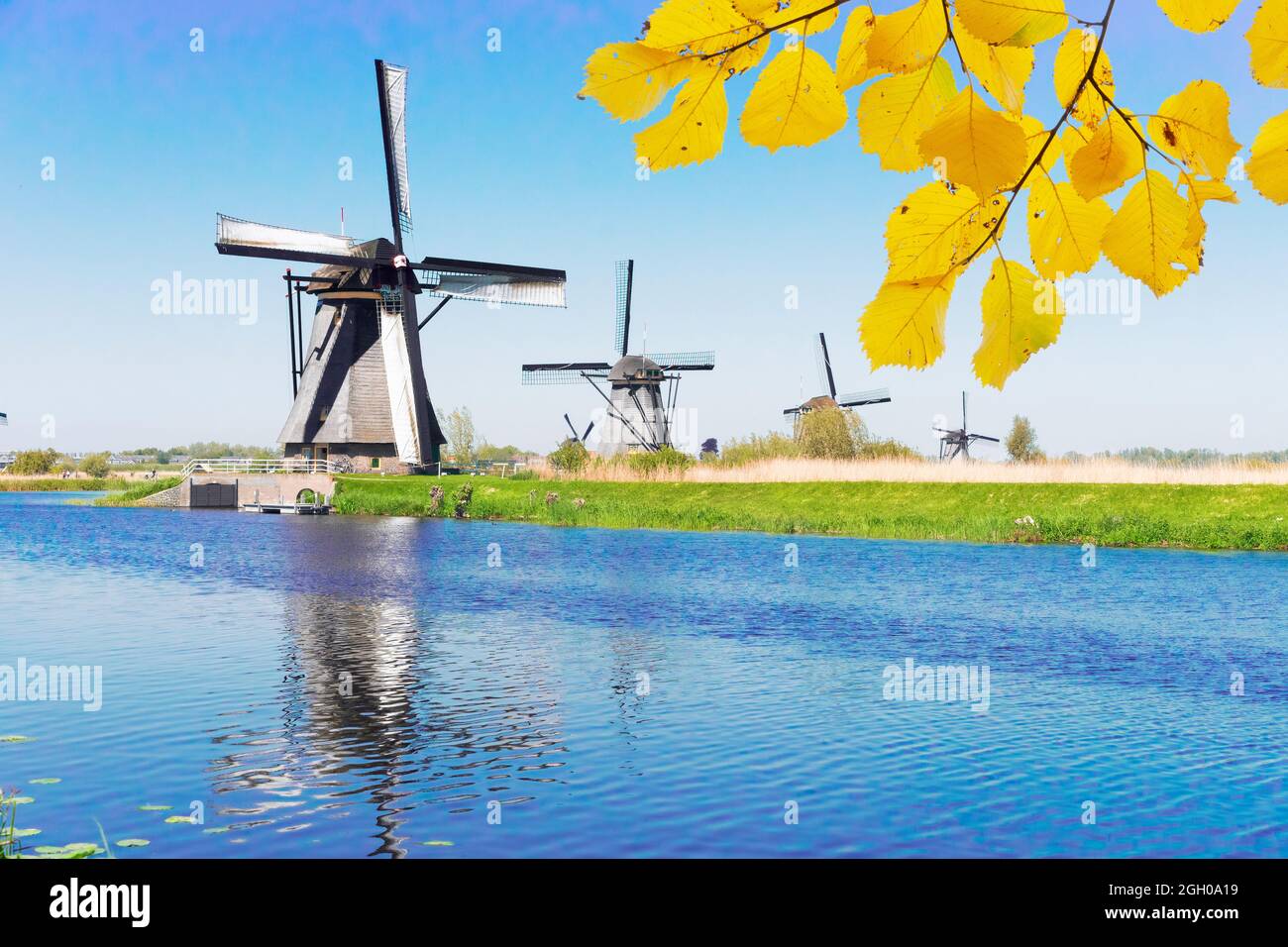 dutch windmill over river waters Stock Photo - Alamy