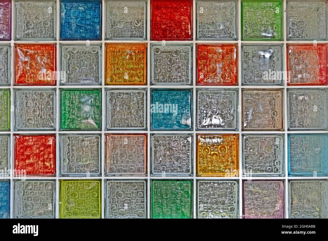 A colorful stained glass window. Rows of glass squares in blue, red ...
