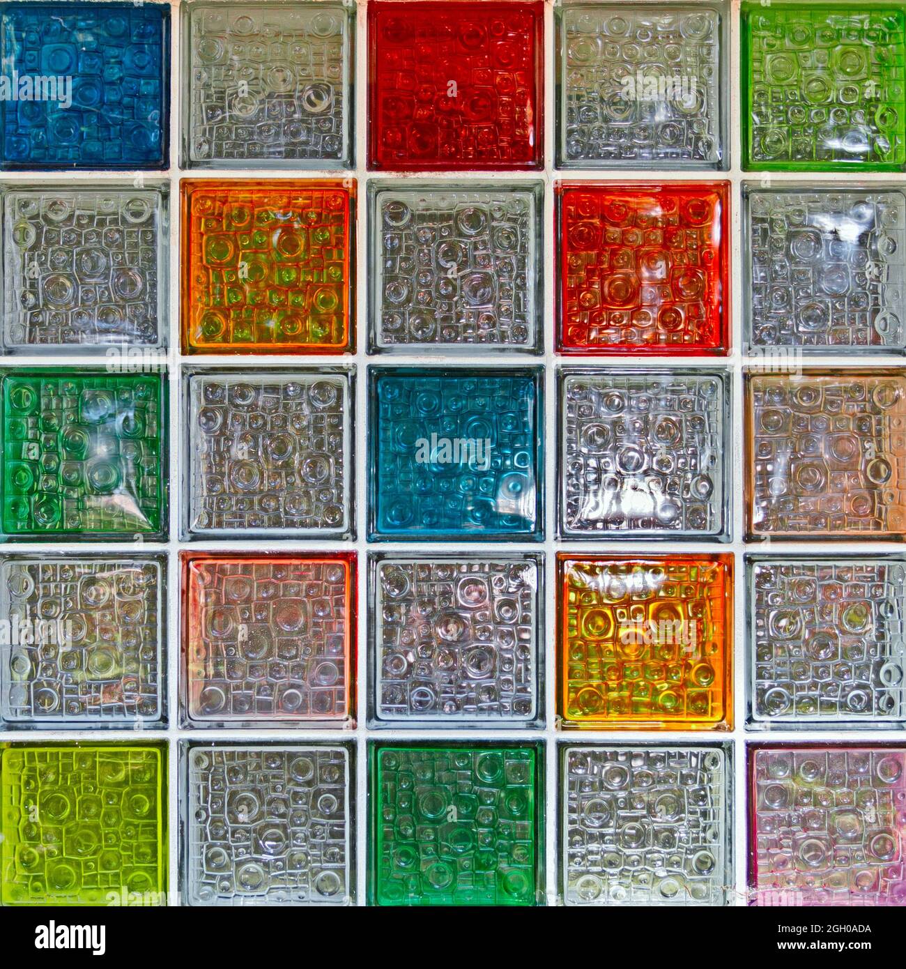 A colorful stained glass window. Rows of glass squares in blue, red ...