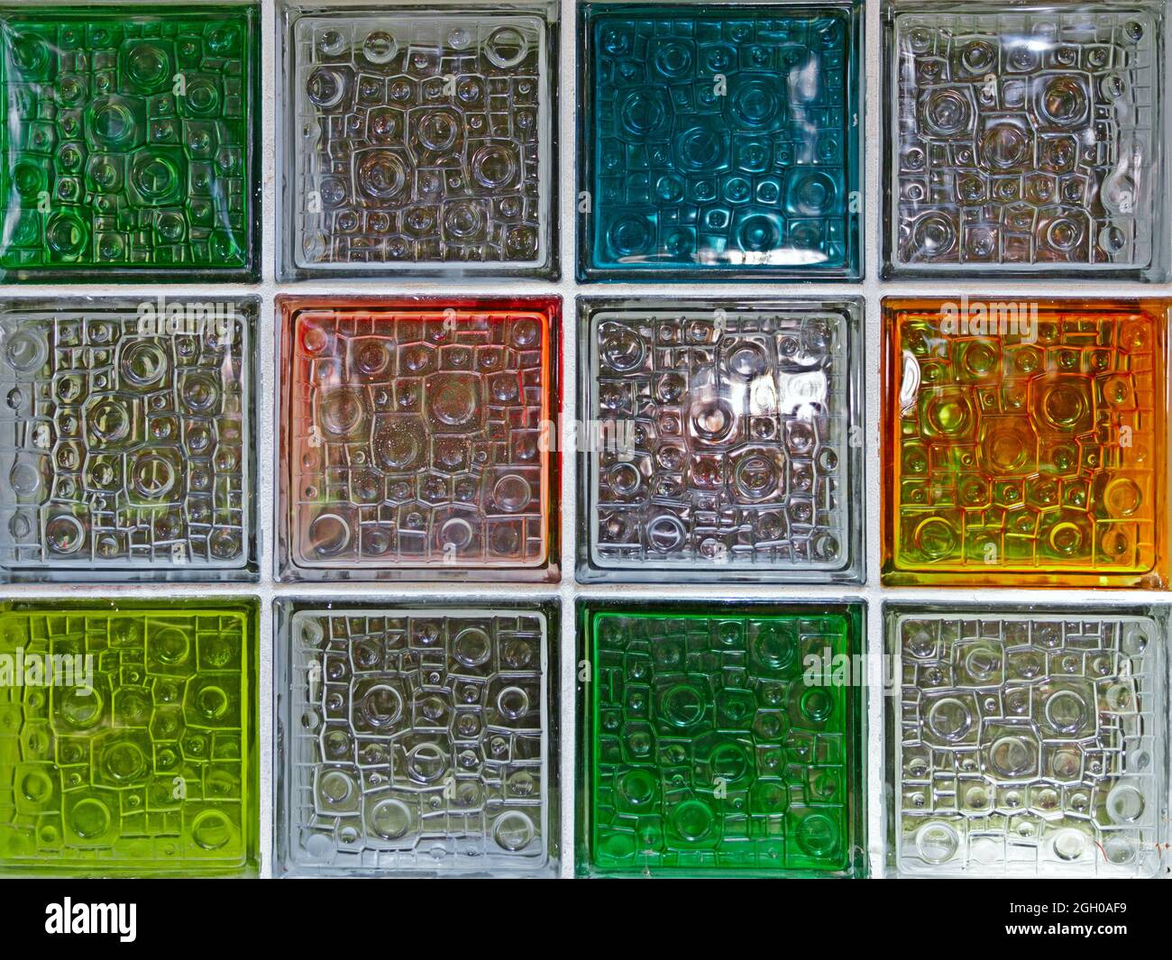 A colorful stained glass window. Rows of glass squares in blue, red ...