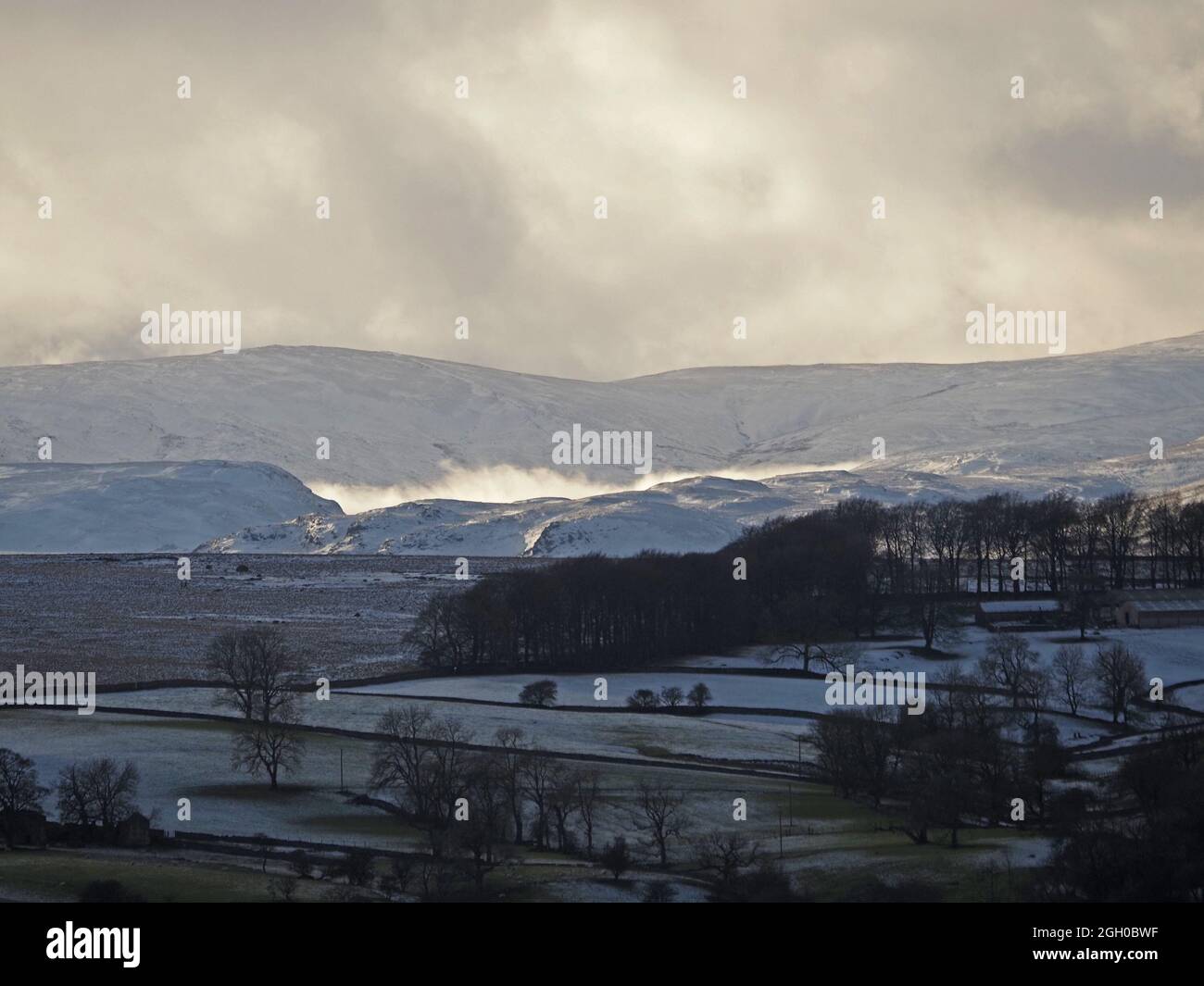 dramatic Winter landscape with brooding storm clouds over High Street ...