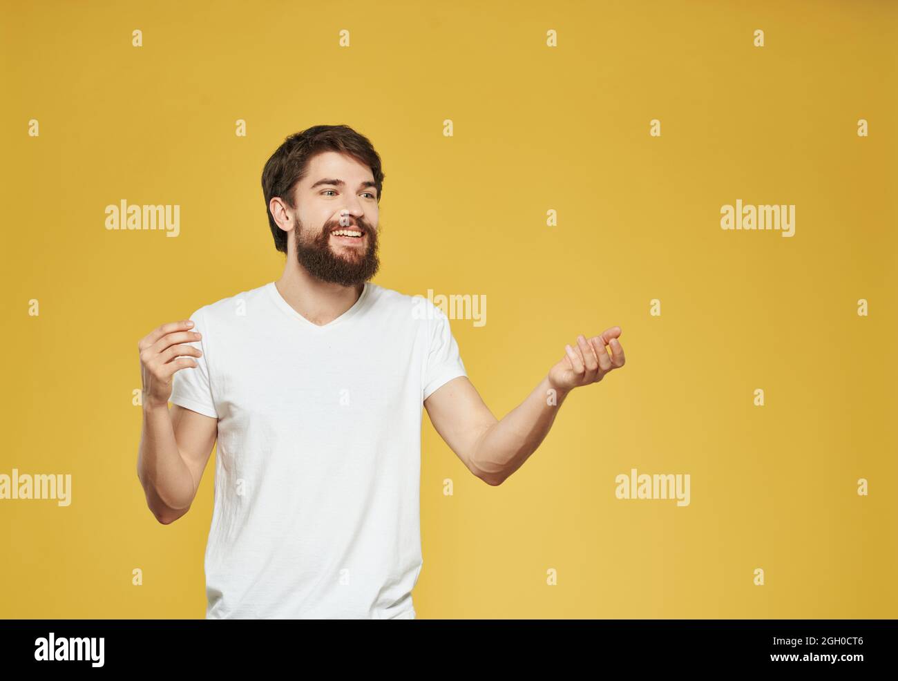 emotional man in a white t-shirt hand gestures anger Studio Stock Photo ...