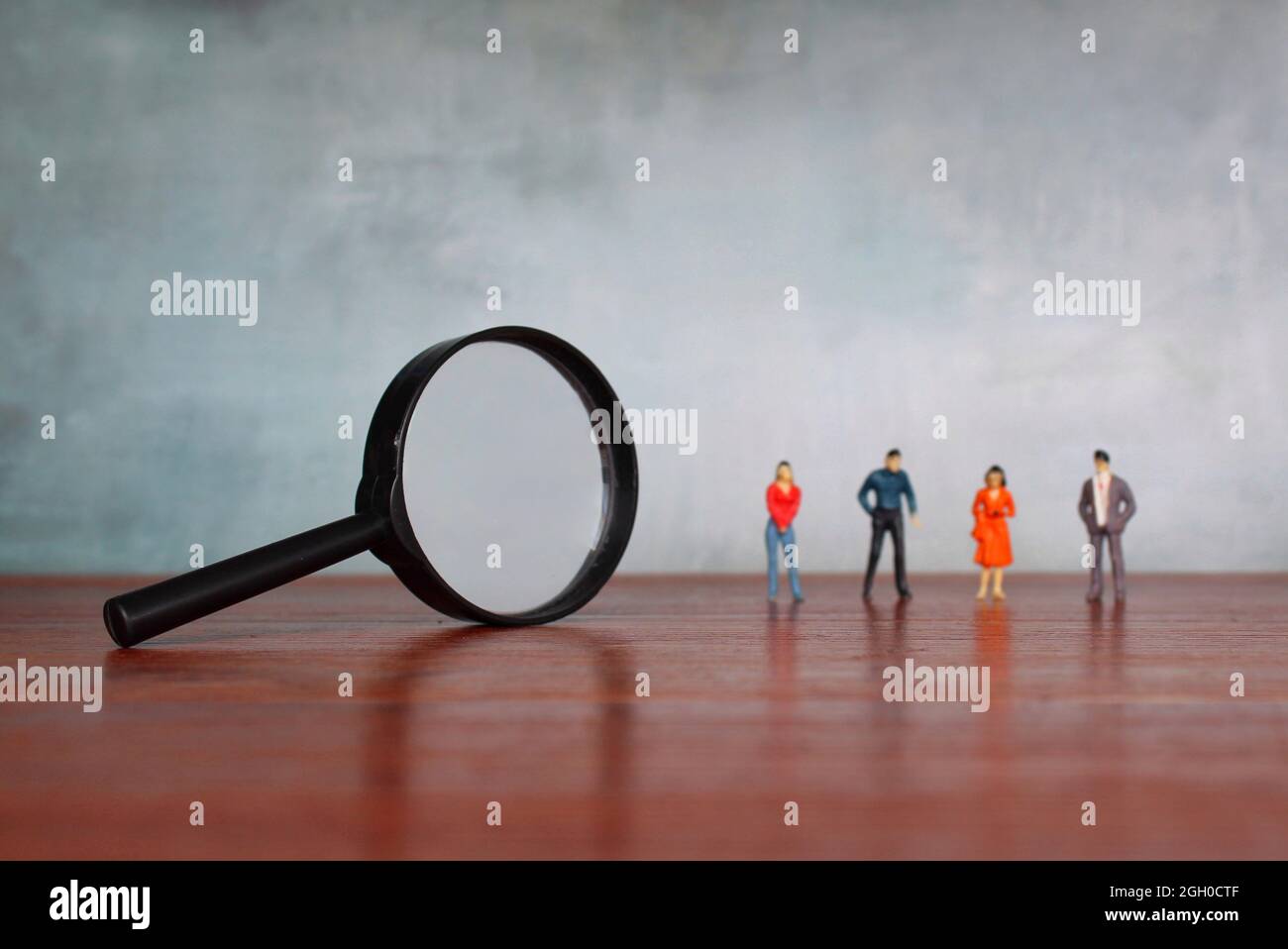 Selective Focus Image Of Magnifying Glass And Miniature People With