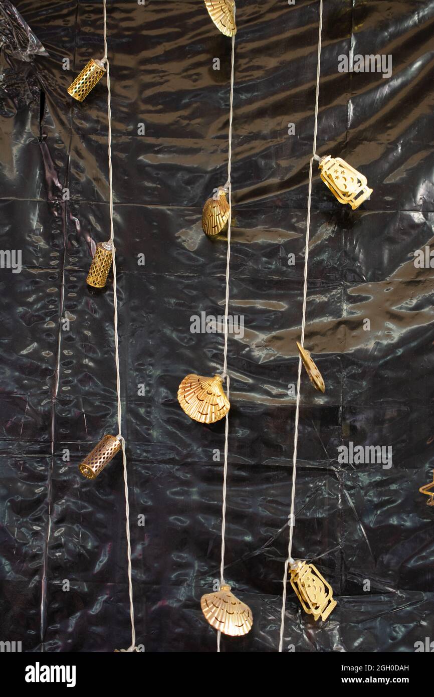 Vertical shot of decorative brass hanging on a string Stock Photo - Alamy