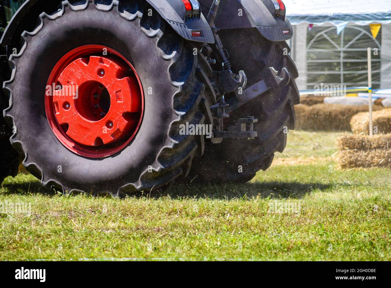 Powerful tractor wheels go over the ground up dust.A small movement ...