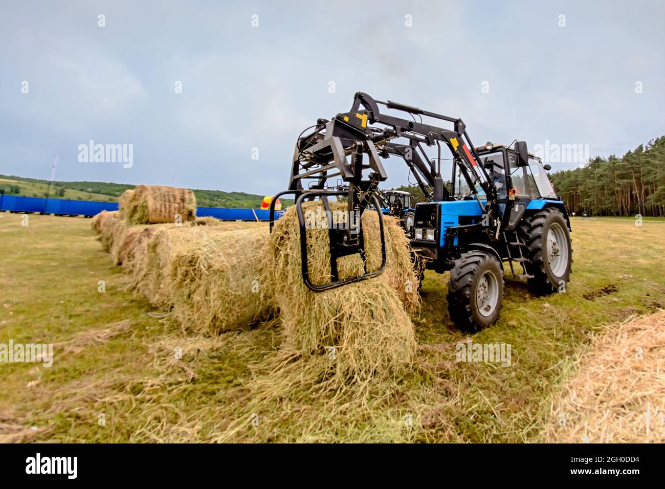 tractor hay stacks in the field. Toning Stock Photo - Alamy